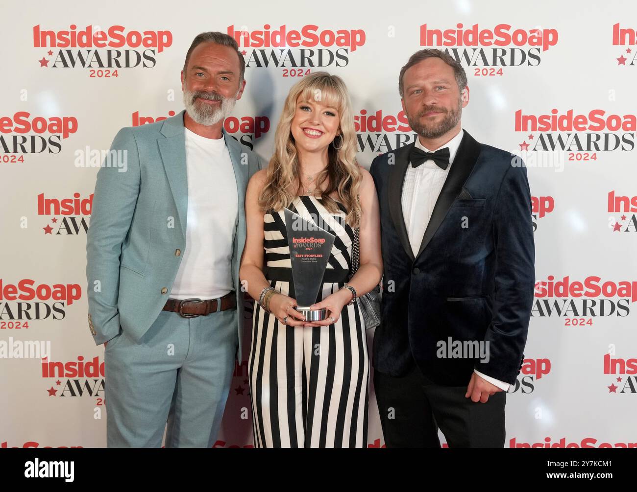 (left to right) Daniel Brocklebank, Harriet Bibby and Peter Ash with the Best Storyline Award at ...