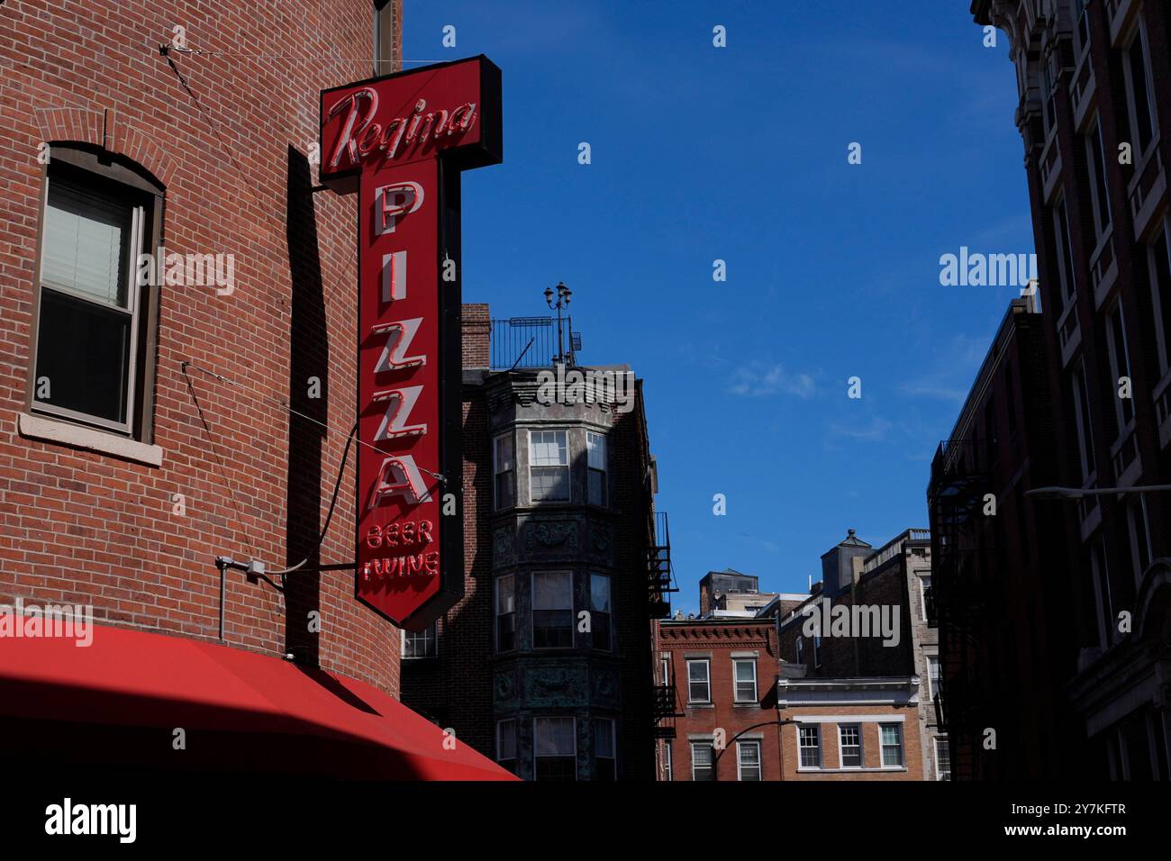 A sign hangs from the facade of the historic Regina Pizzeria in the ...