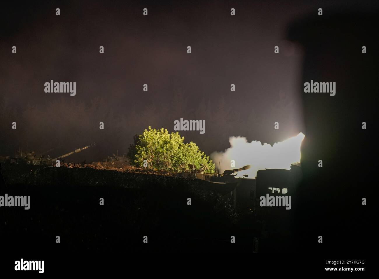 An Israeli mobile artillery unit fires a shell from northern Israel ...