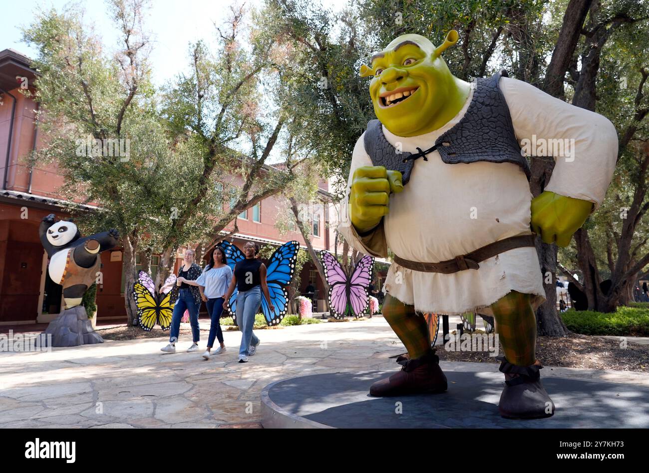 DreamWorks employees walk past statues of animated characters Shrek ...