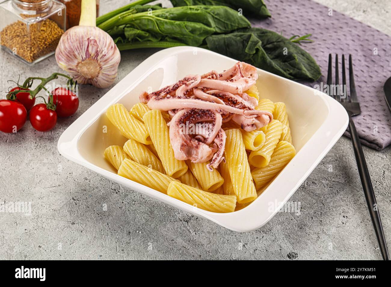 Italian cuisine - pasta tortiglioni with squid tentacles Stock Photo ...