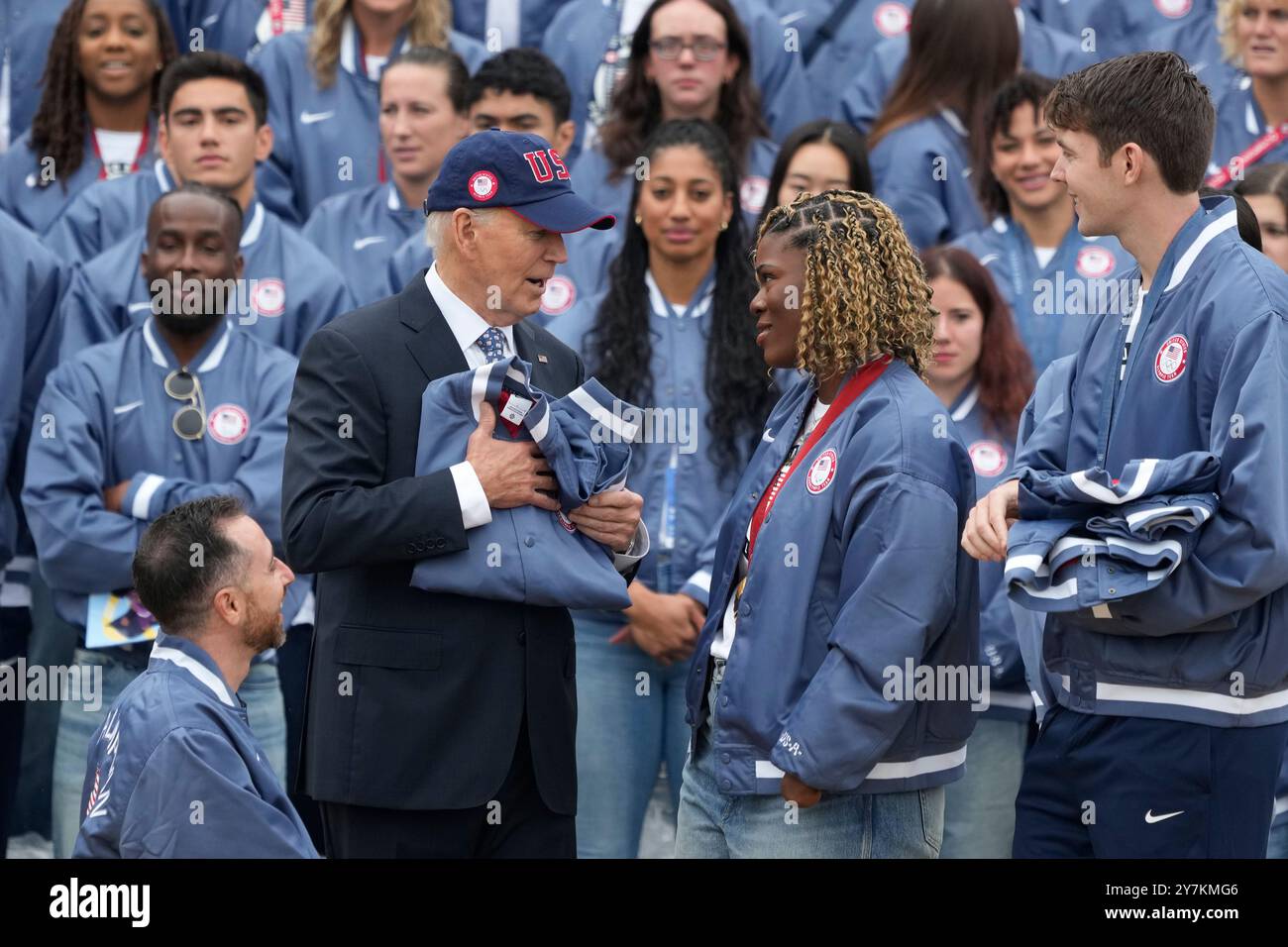 United States President Joe Biden receives team jackets from athletes ...