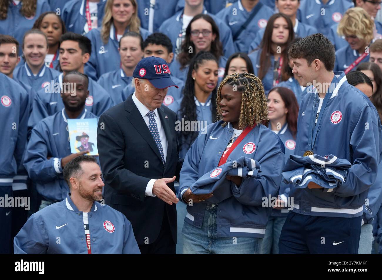 United States President Joe Biden receives team jackets from athletes ...