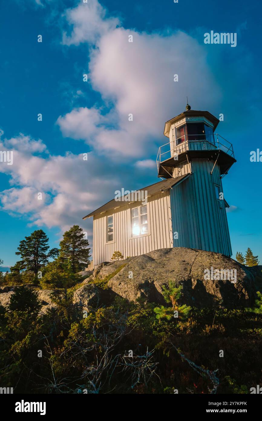 Wooden lighthouse on rocky terrain with a blue sky and clouds, RATAN ...