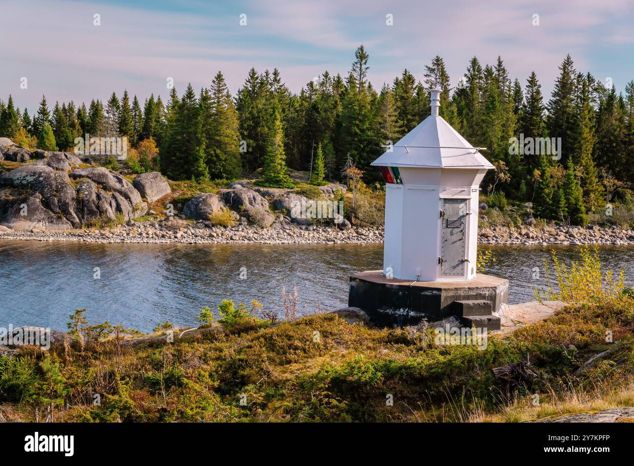 Scenic Scandinavian nature with forest and small lighthouse by rocky ...