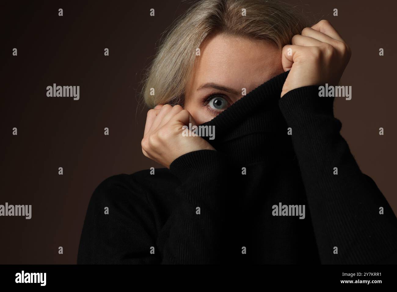 Portrait of scared woman on brown background Stock Photo - Alamy