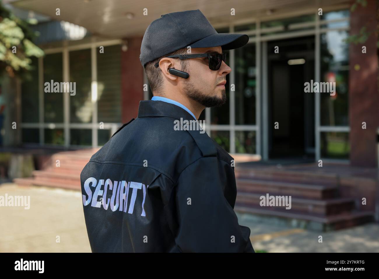 Security guard in uniform and sunglasses outdoors Stock Photo - Alamy