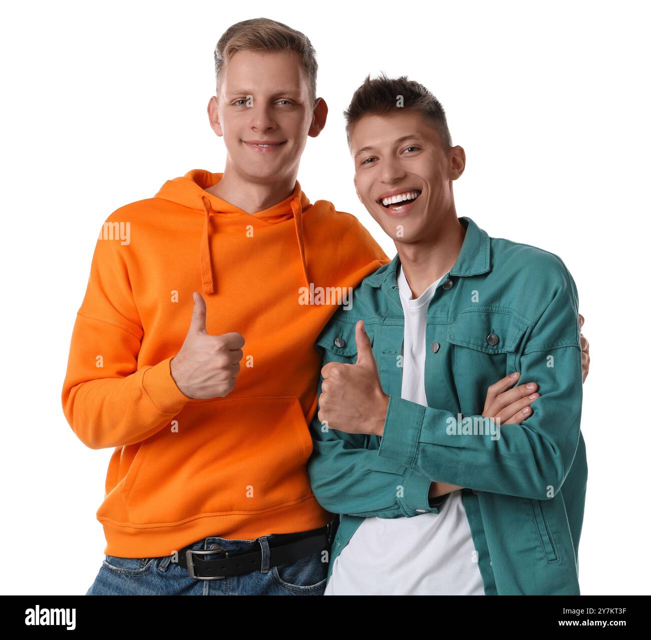 Two young brothers showing thumbs up on white background Stock Photo ...