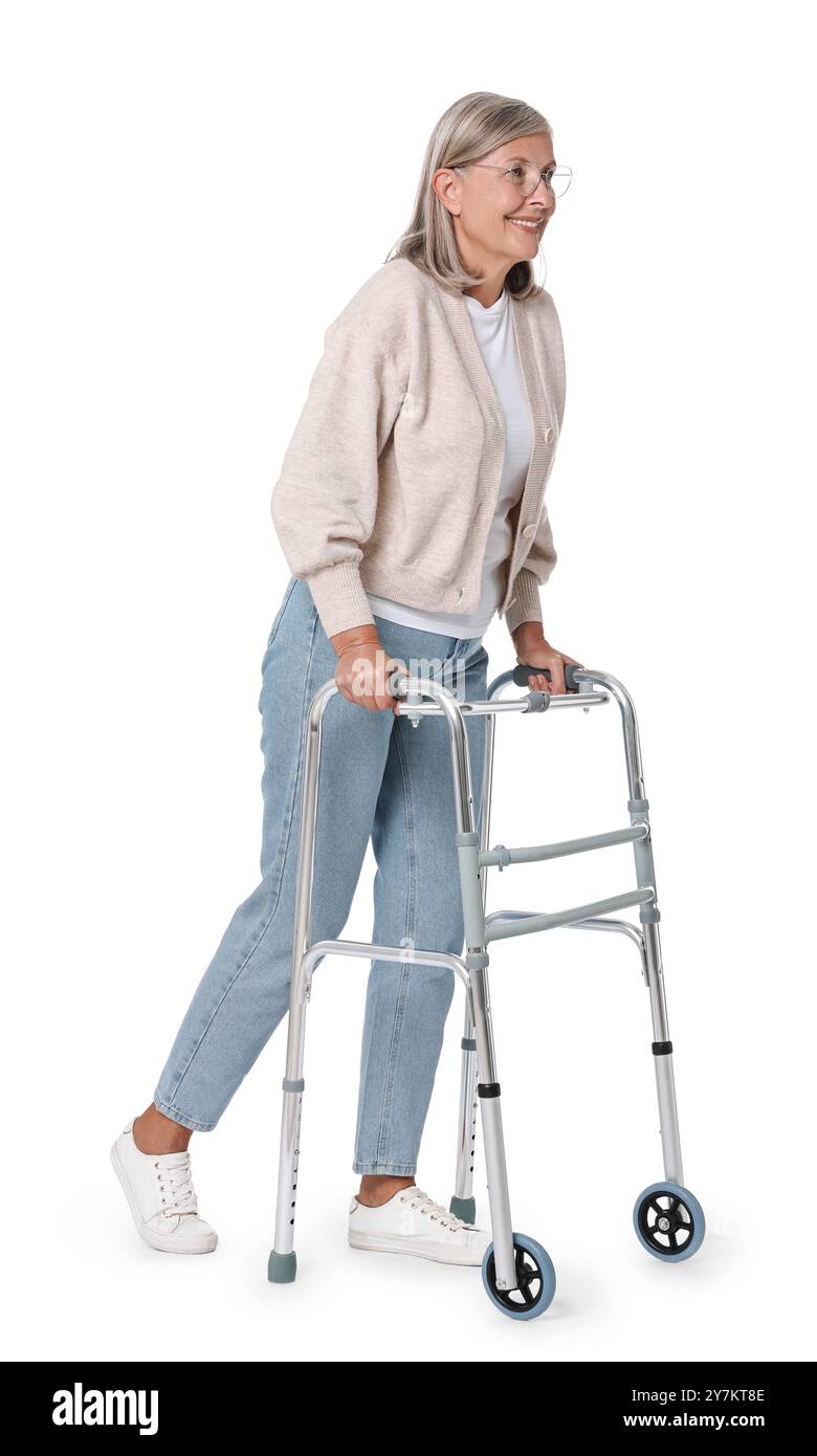 Senior woman using walking frame on white background Stock Photo - Alamy