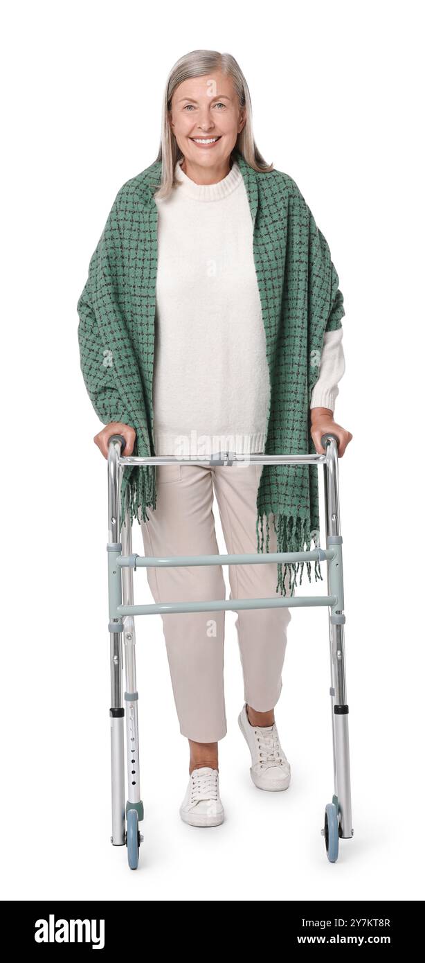 Senior woman using walking frame on white background Stock Photo - Alamy