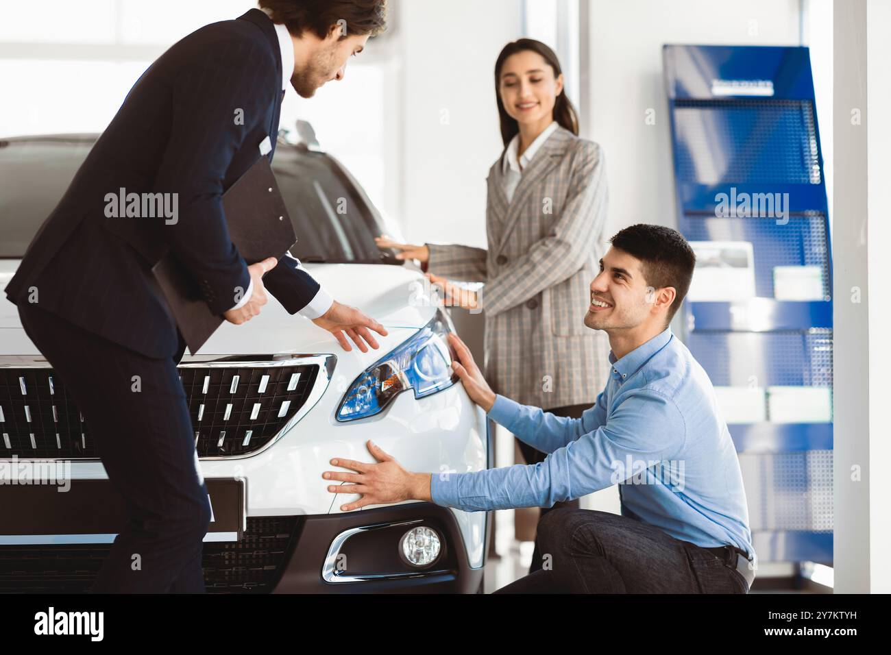 Happy Guy Touching His Auto In Dealership Showroom Stock Photo - Alamy