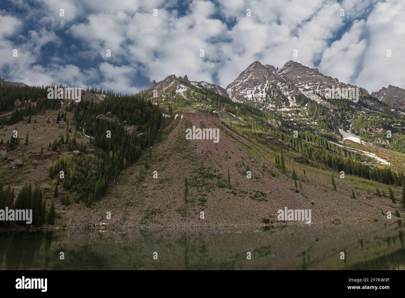 Maroon Bells Lake nestled at the bottom of the Elk Mountains, with snow ...