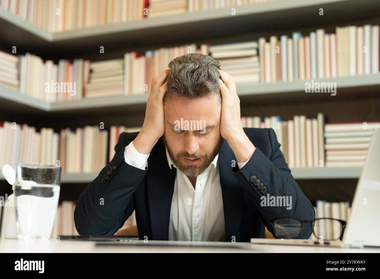 Business man suffering from headache after computer work, exhausted ...