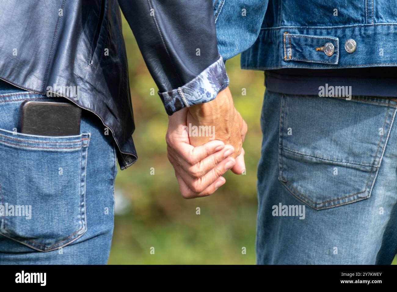 Couple holding hands in jeans, supporting midlife relationship, love ...