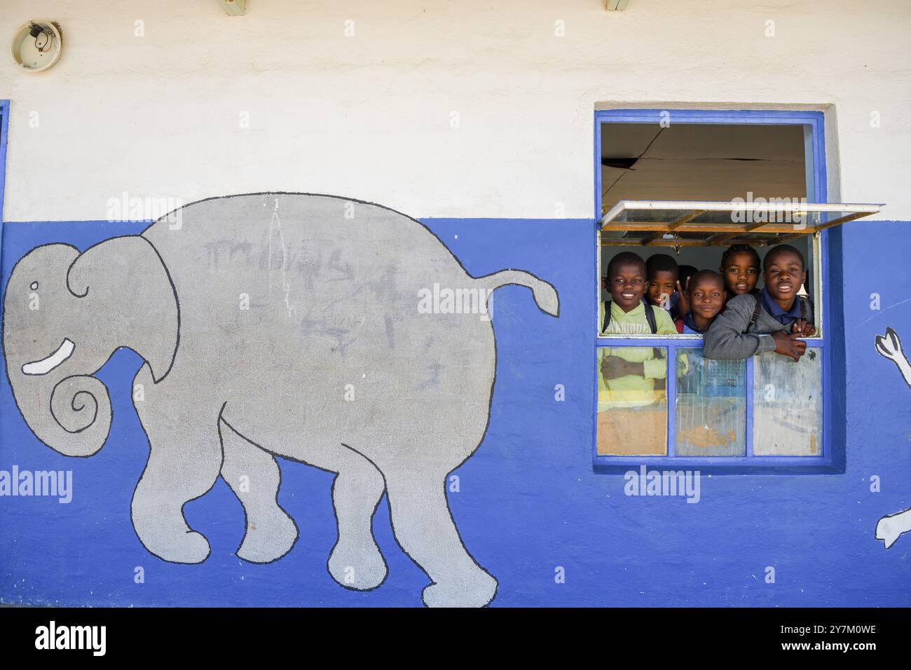 Children look out of the window of their classroom at Gariseb Primary ...