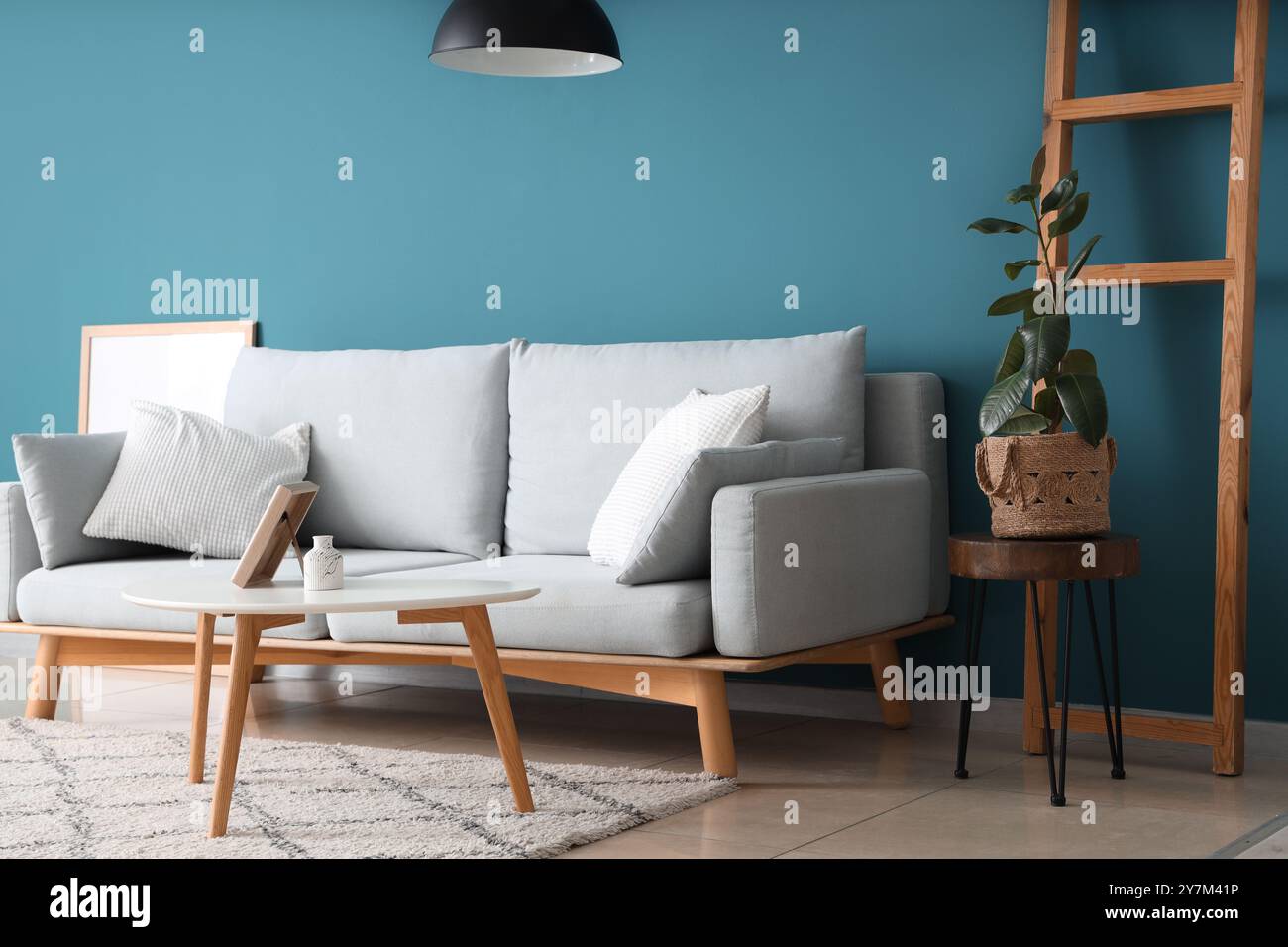 Interior of living room with wooden ladder, sofa and tables Stock Photo ...