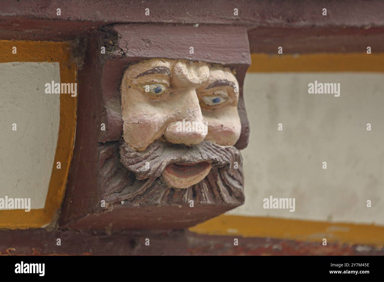 Wood carving with envious head symbolising envy, resentment, jealousy ...
