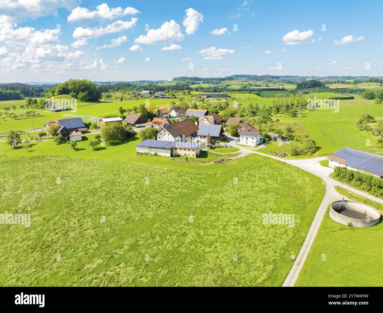 Aerial view of an extensive meadow landscape with a village and farms ...