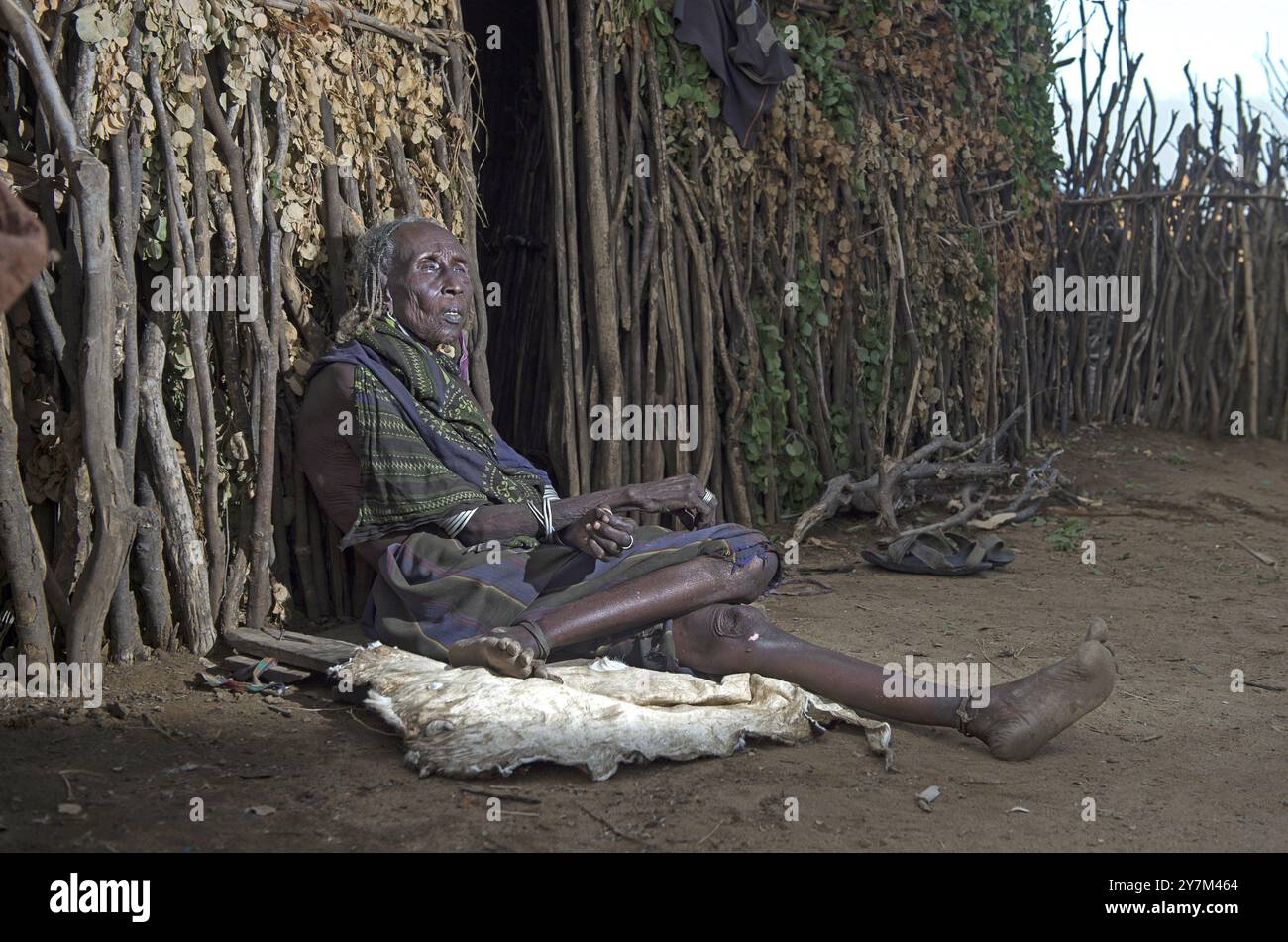 Ethnic group of the Arbore: Old woman sitting in front of her hut ...