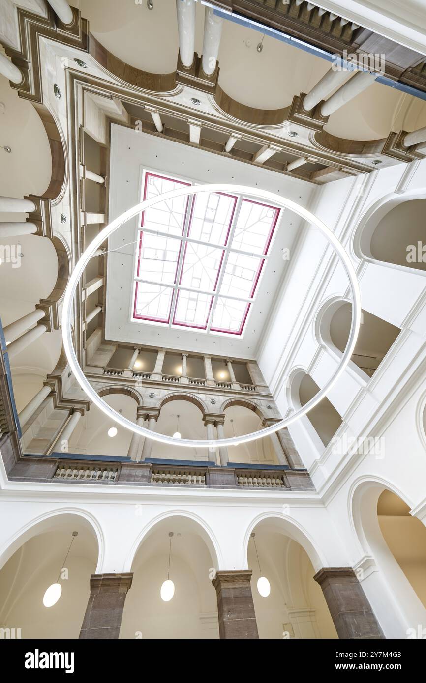 Modern interior with high ceiling, columns and a large circular ...