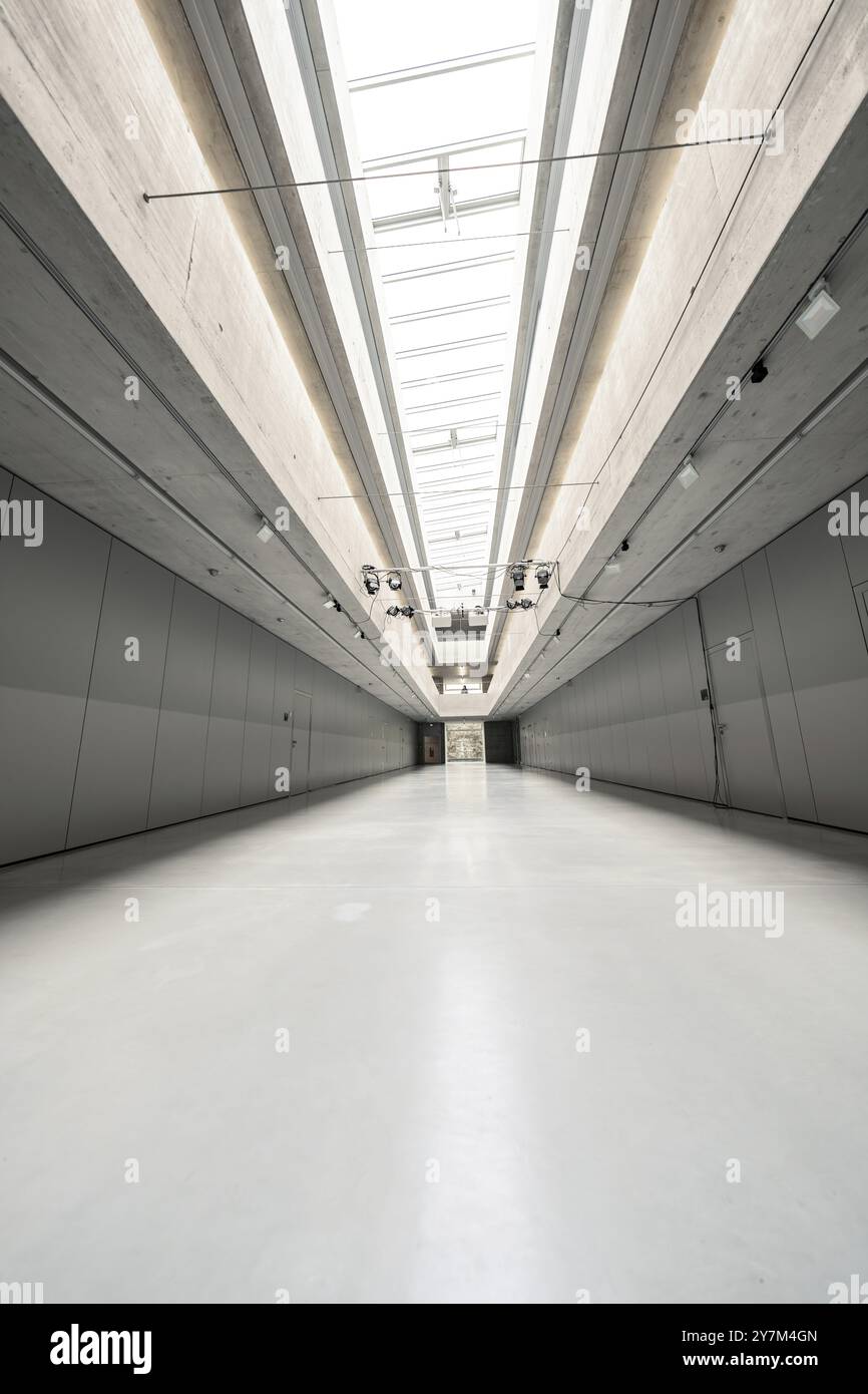 An ultra-modern, empty space with high ceilings and glass and concrete ...