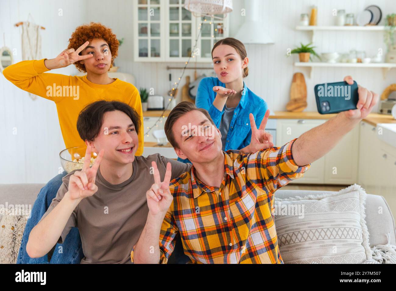 Cheers Funky mood. Happy group of friends make selfie. Man taking photo of friends at party ...