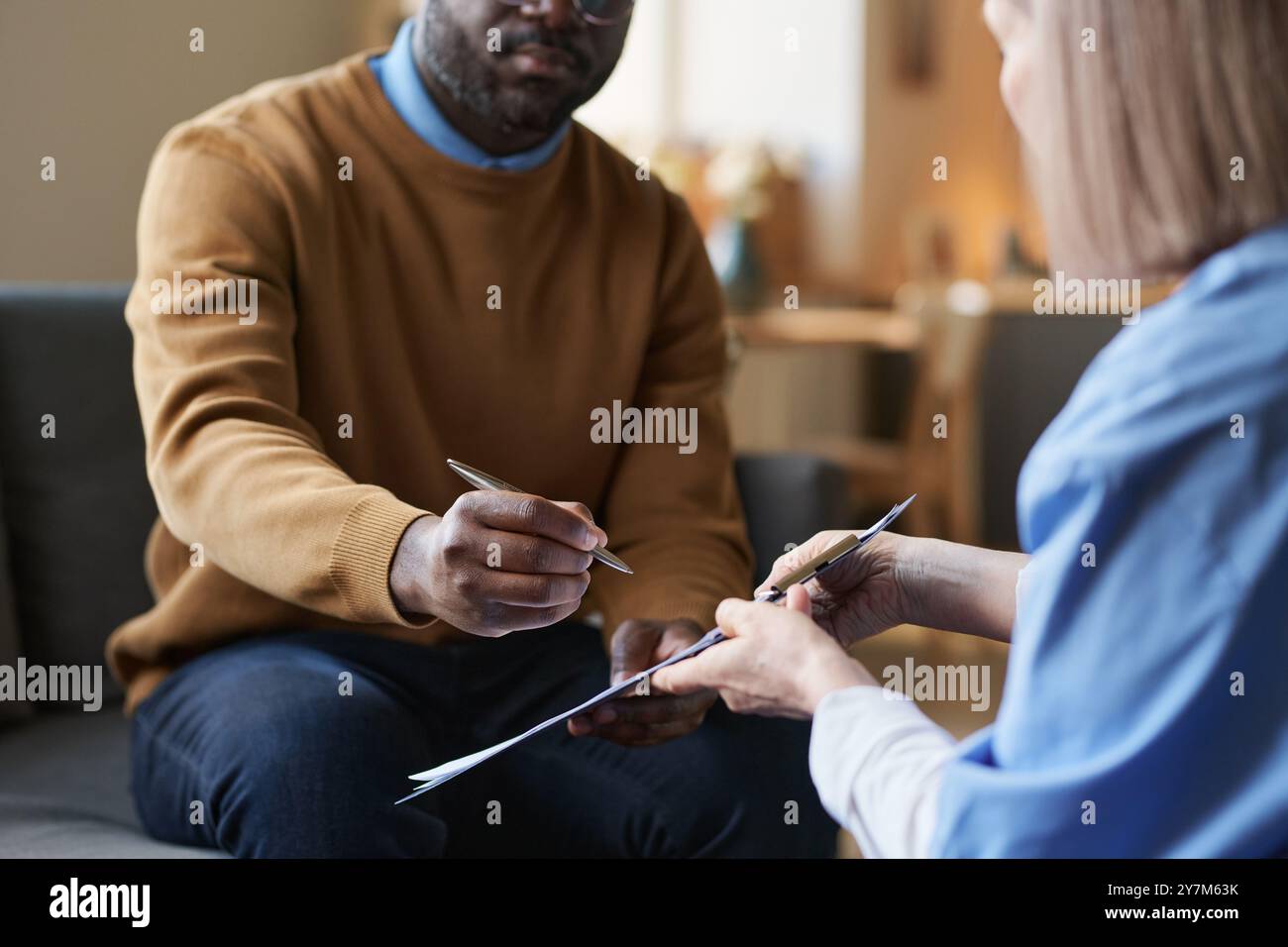 Closeup of Black Man Signing Form Stock Photo - Alamy