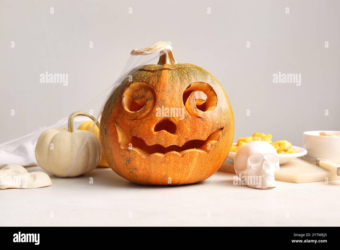 Halloween carved pumpkins with human skull on white background Stock ...