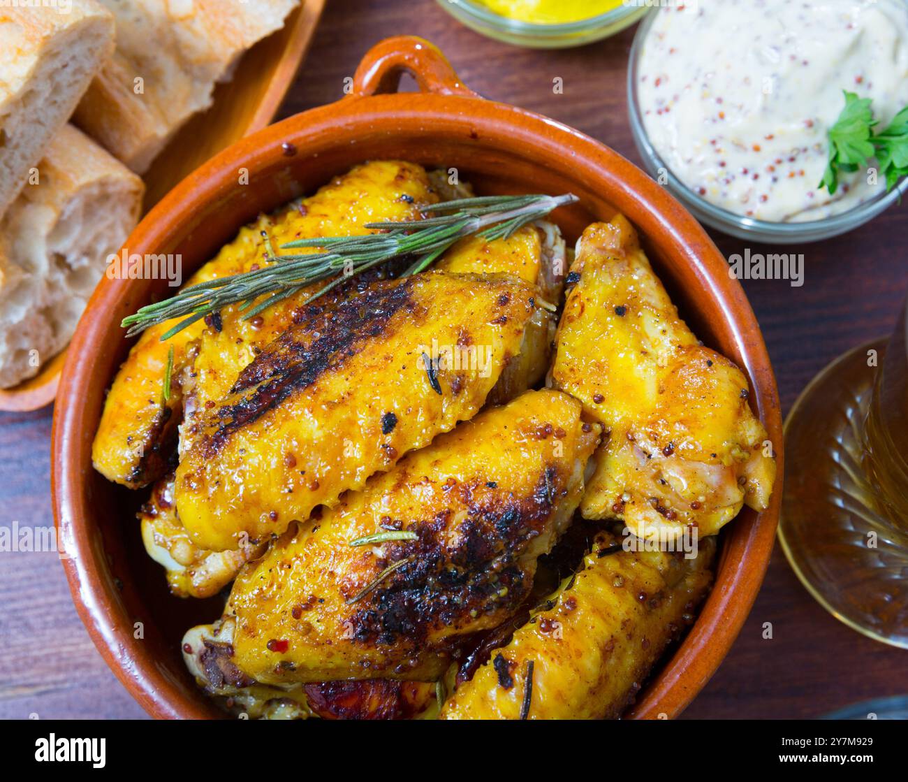 Roasted chicken wings in clay bowl Stock Photo - Alamy