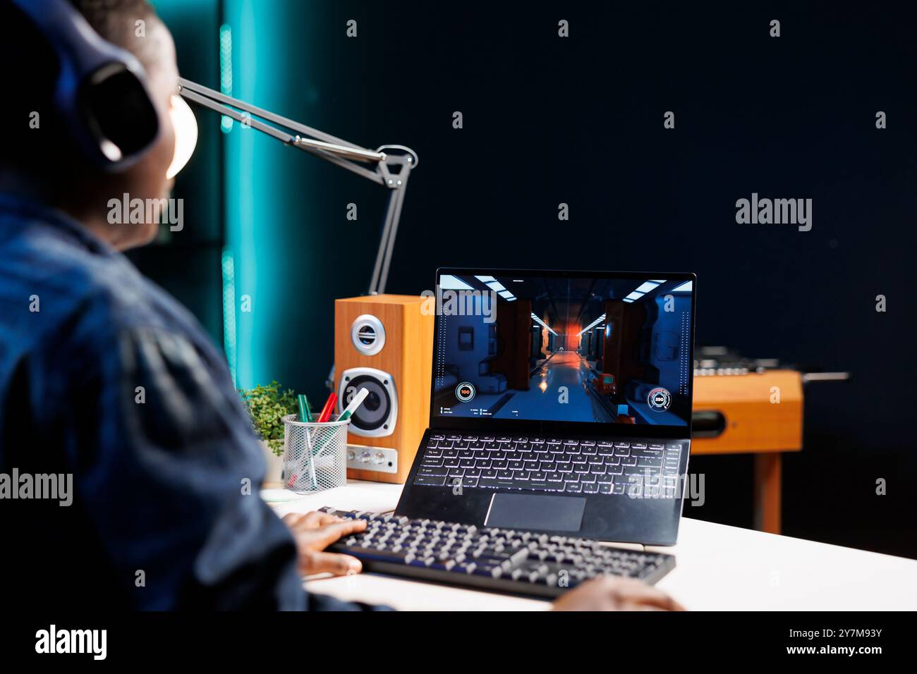 Focused African American player enjoys competitive gaming on digital ...