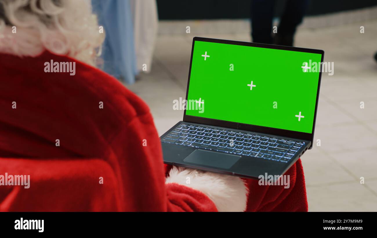 Manager in Christmas adorn shopping mall dressed as Santa Claus holding ...