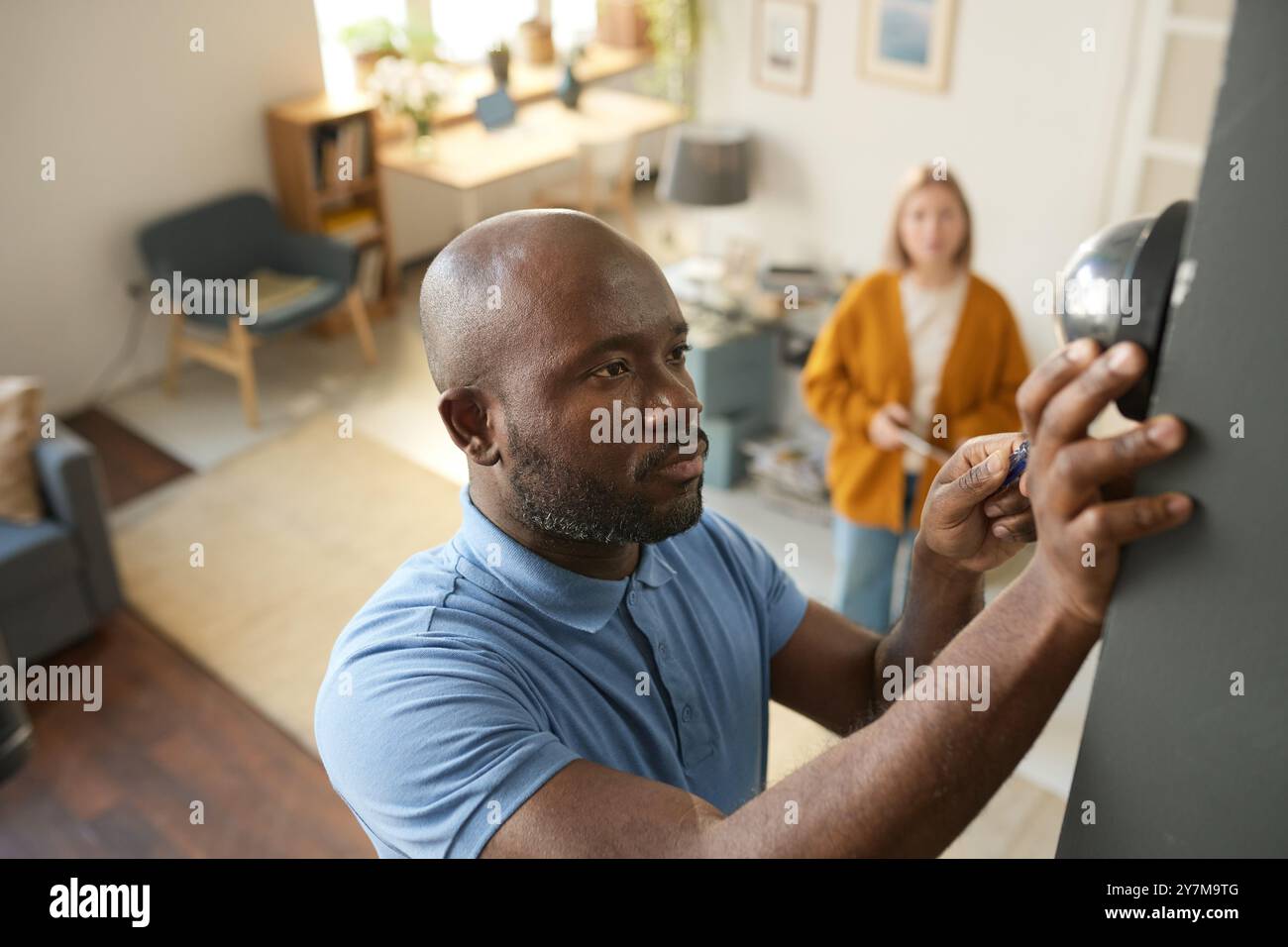 Black Man Doing Home Maintenance Service Stock Photo - Alamy