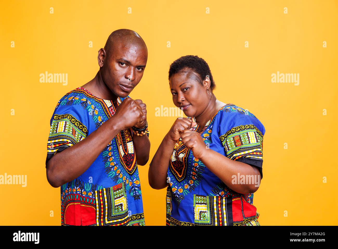 Serious african american couple standing in fighting pose with clenched ...