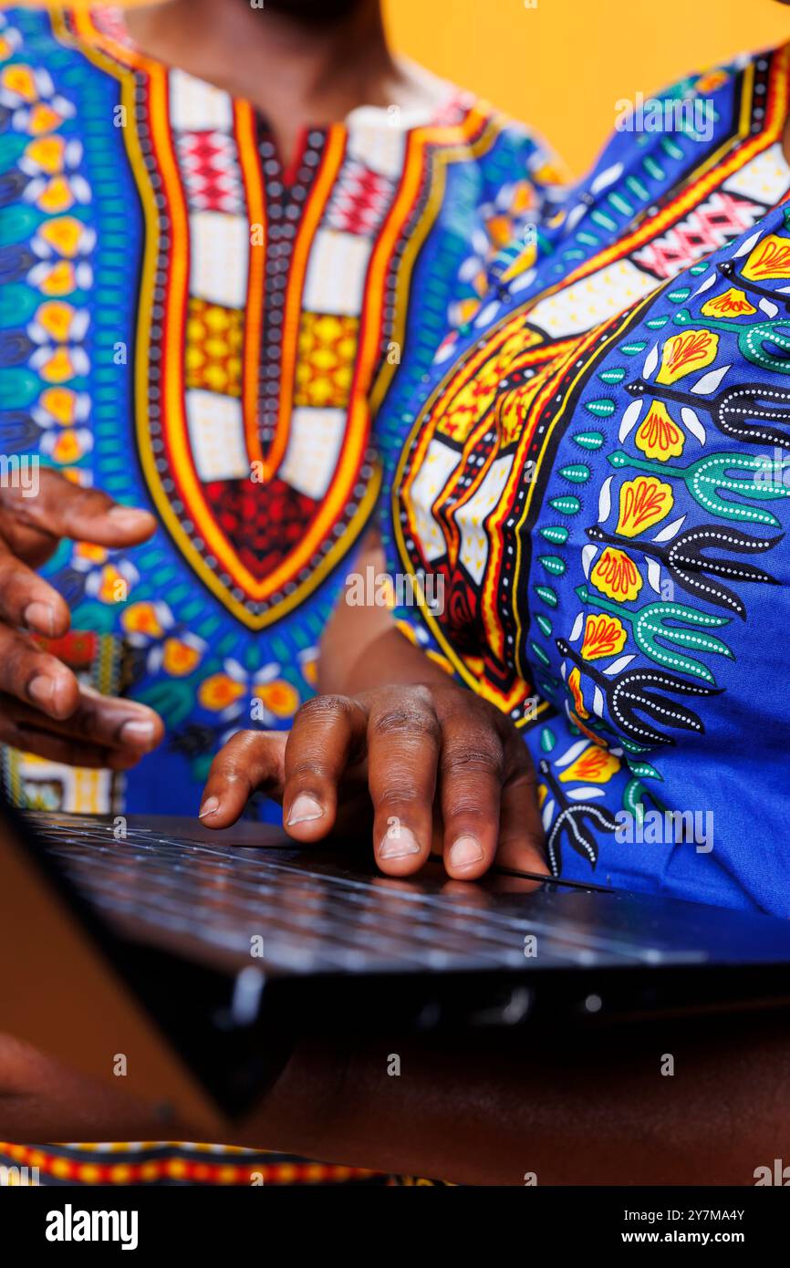 Black man and woman using laptop and scrolling internet page with ...