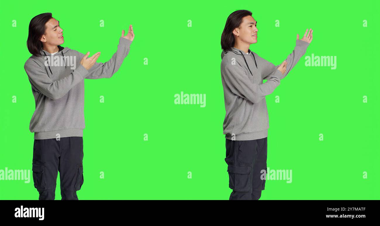 Asian guy doing advertisement on camera, pointing at something next to ...