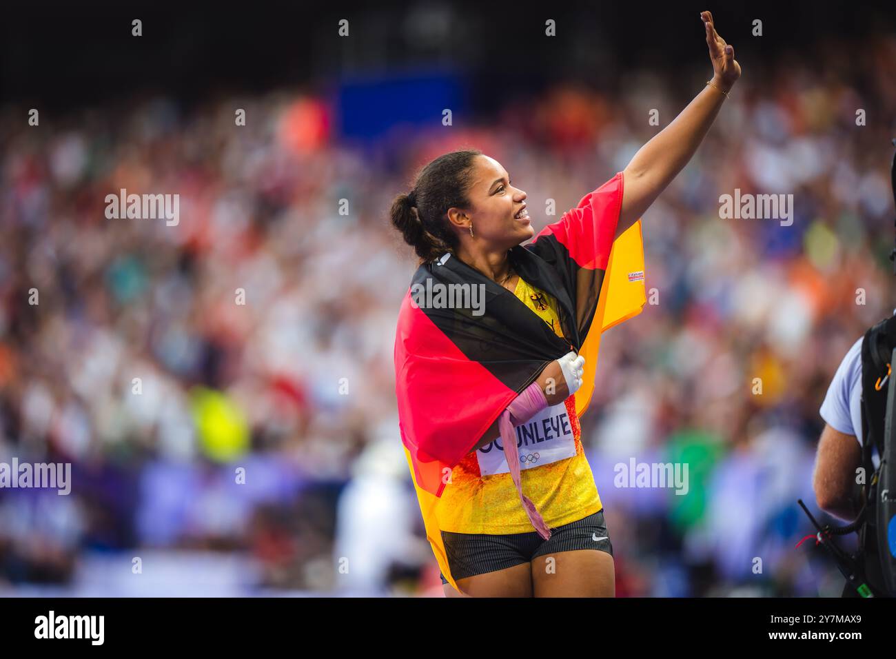 Yemisi Ogunleye celebrating with their country's flag at the Paris 2024 ...