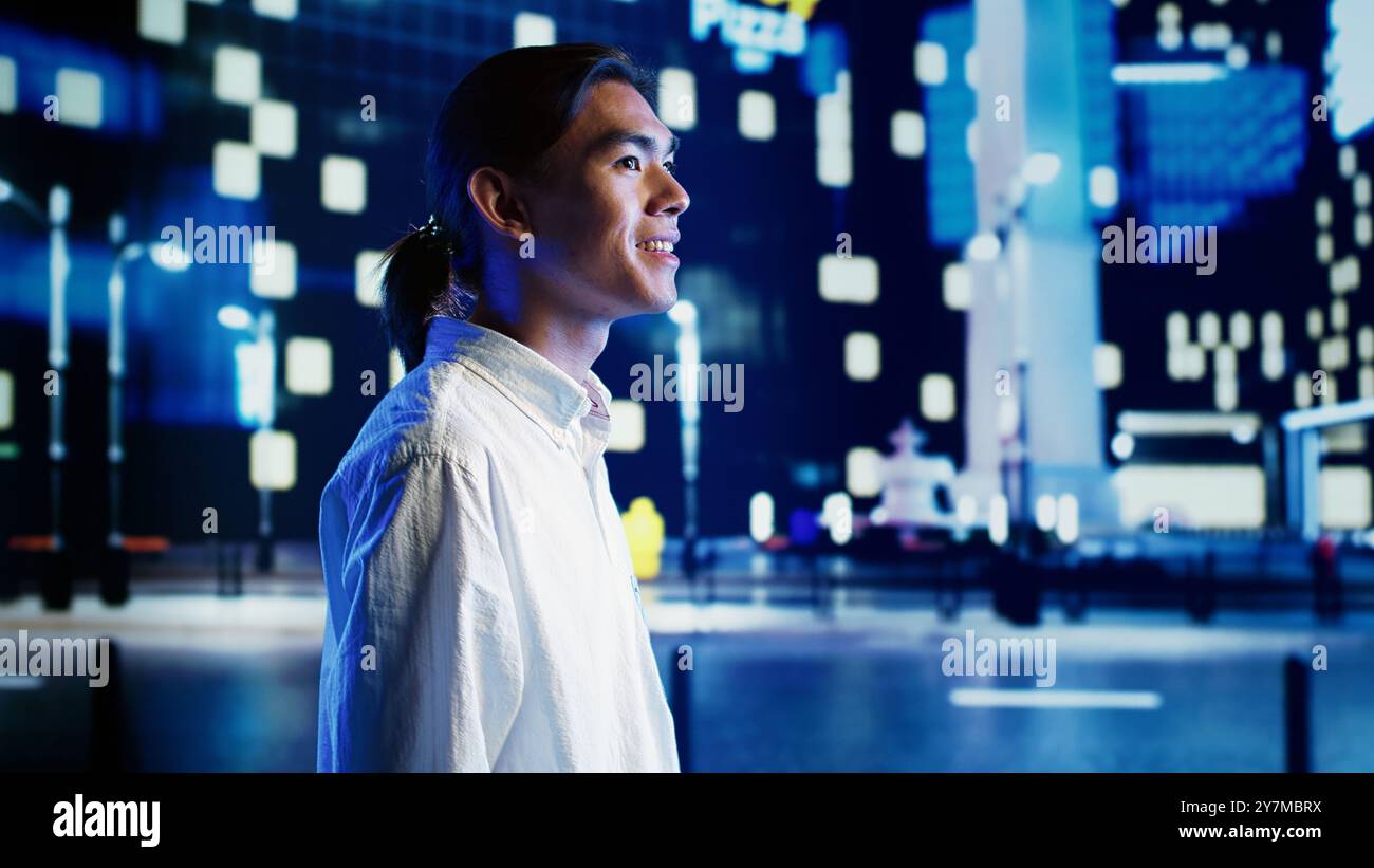 Relaxed asian man wandering around city streets at night, looking ...