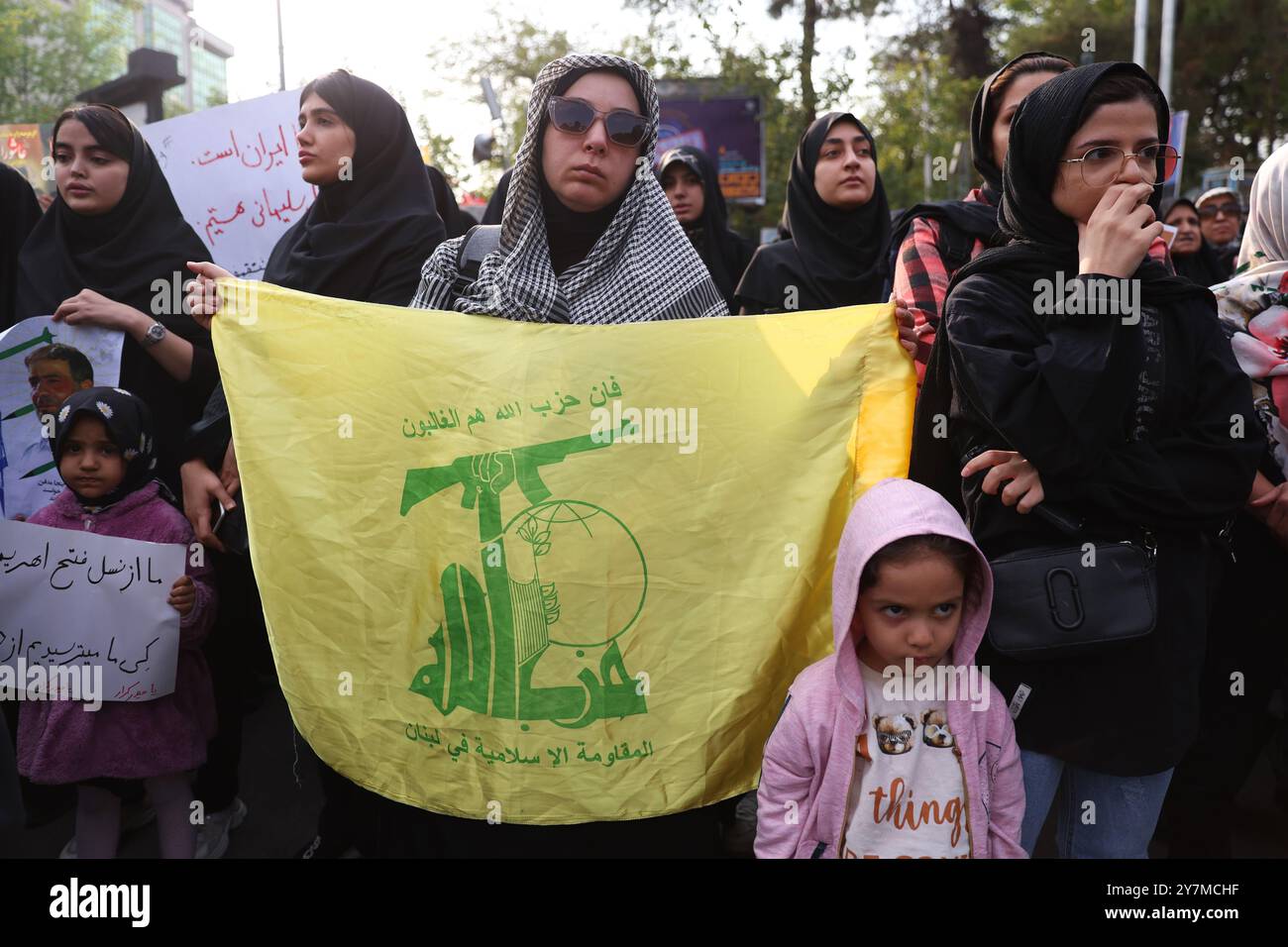 Tehran, Iran. 30th Sep, 2024. A mourner holds up a Hezbollah flag ...