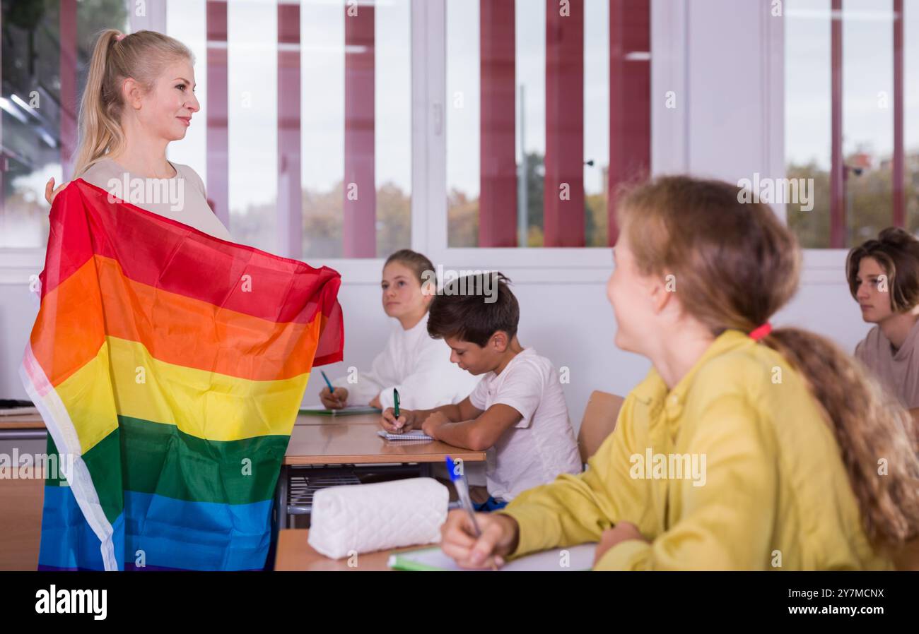 Teacher explaining LGBT flag meaning for kids during lesson Stock Photo ...