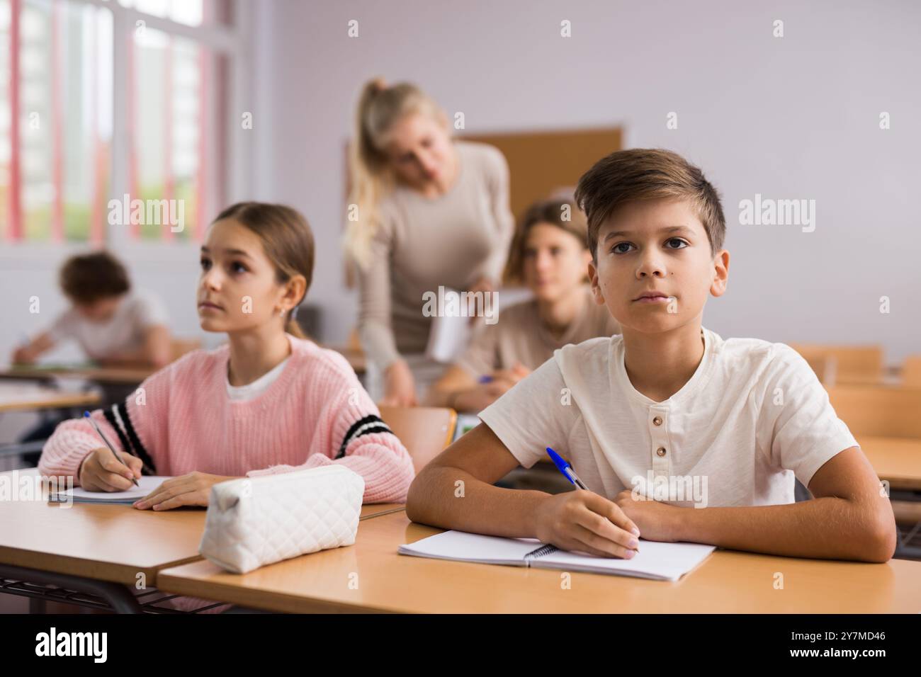 Group of school kids and teacher during lesson Stock Photo - Alamy