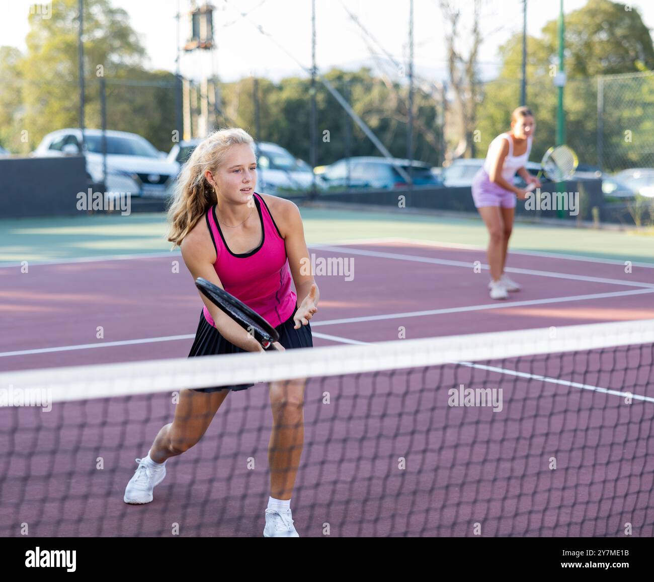 Female player playing tennis in tennis court outdoor behind net Stock ...