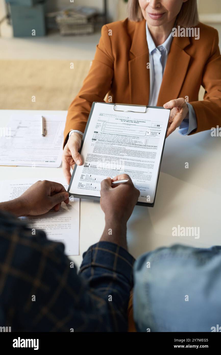 Black Man Signing Tax Declaration Form Stock Photo - Alamy