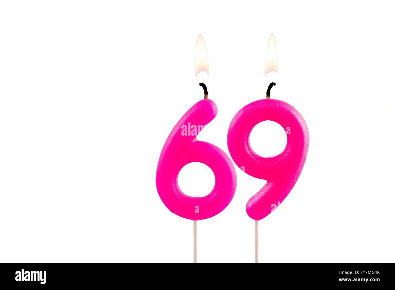 Pink number 69 birthday candle on white background Stock Photo - Alamy
