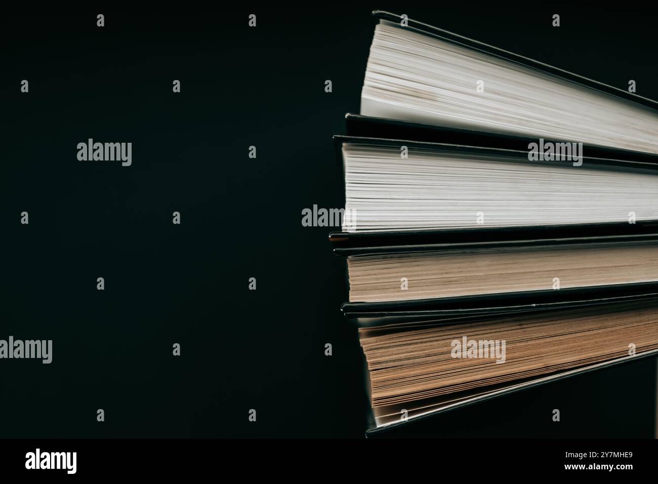 Books with black covers on a black background. Books about magic ...