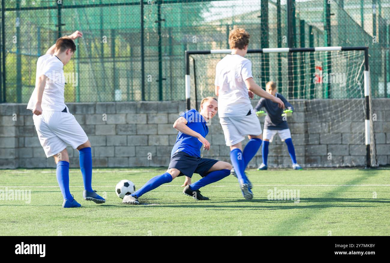 Teens playing soccer football match. Competition between two youth ...
