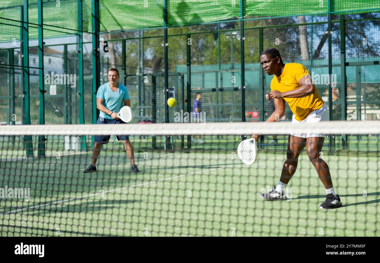 Men in sportswear playing padel tennis match Stock Photo - Alamy