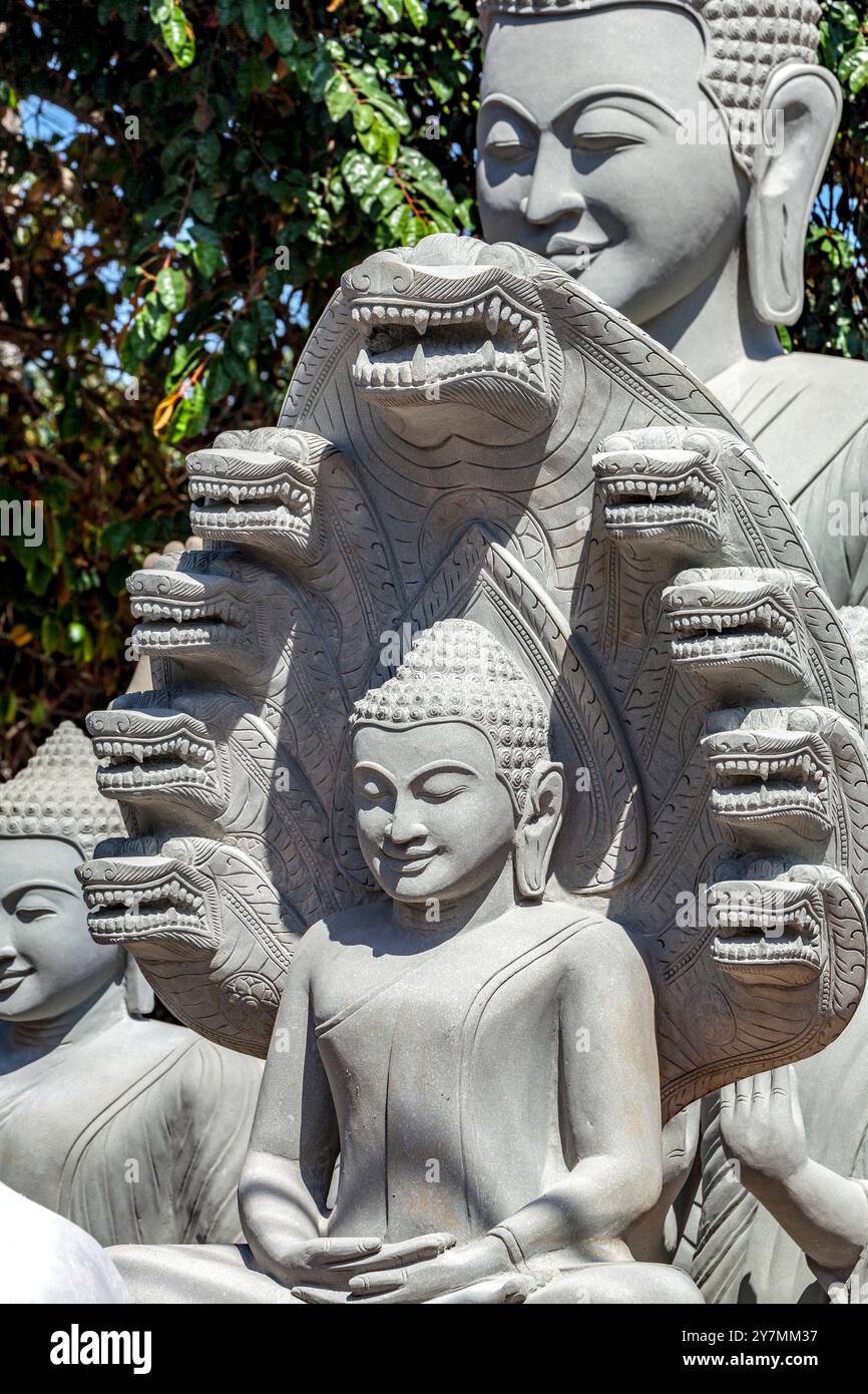 Modern stone carvings of buddhas and a naga at a stonemason shop ...