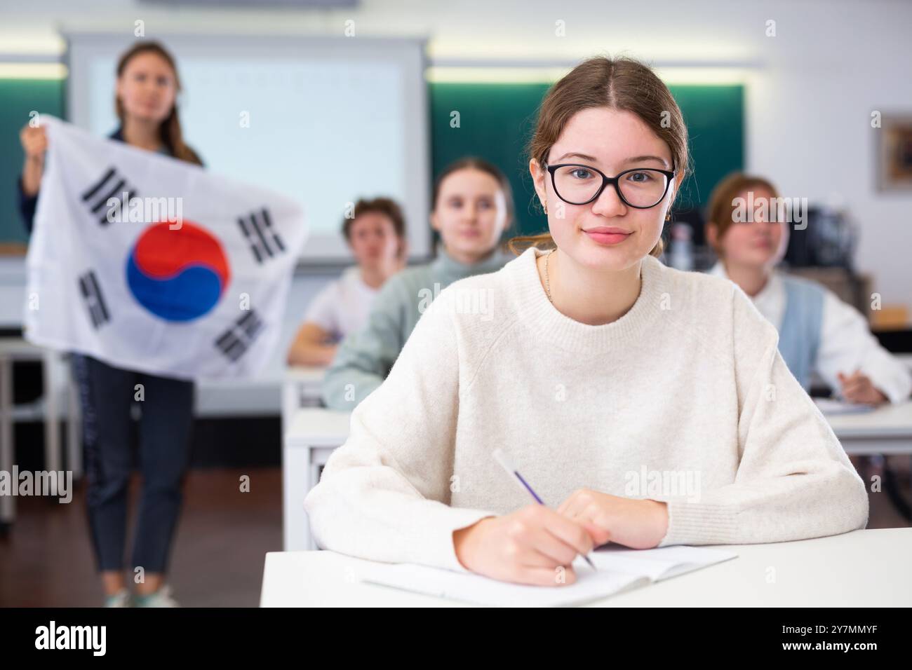 High school teacher holds the flag of South Korea in her hands and ...