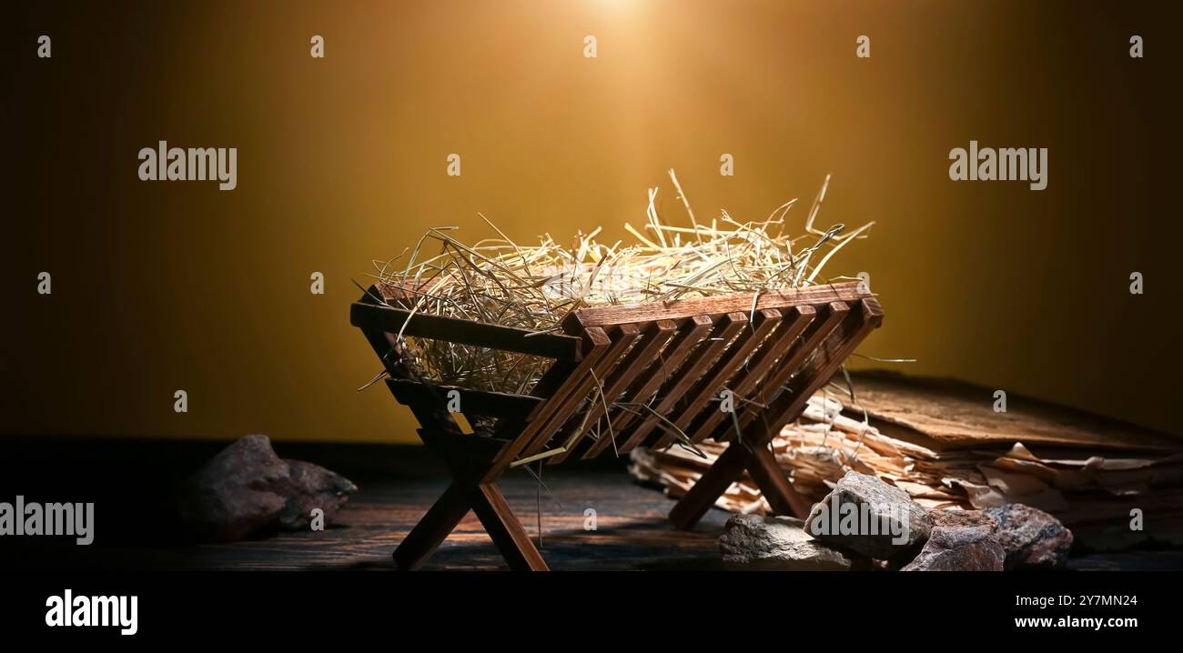 Manger with hay and old book on dark background. Concept of Christmas ...