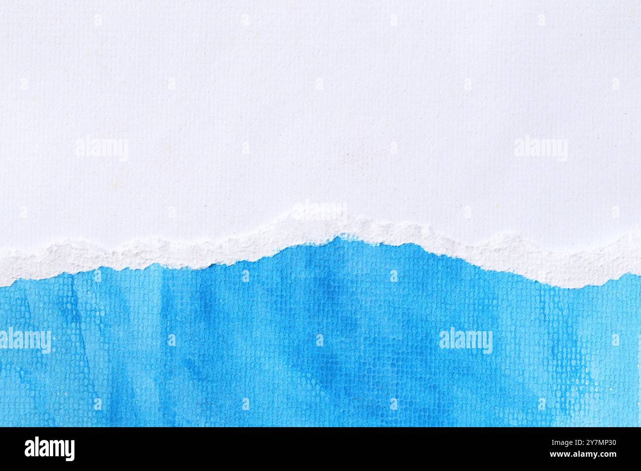 Art paper with blue watercolors on the white art paper and torn ...